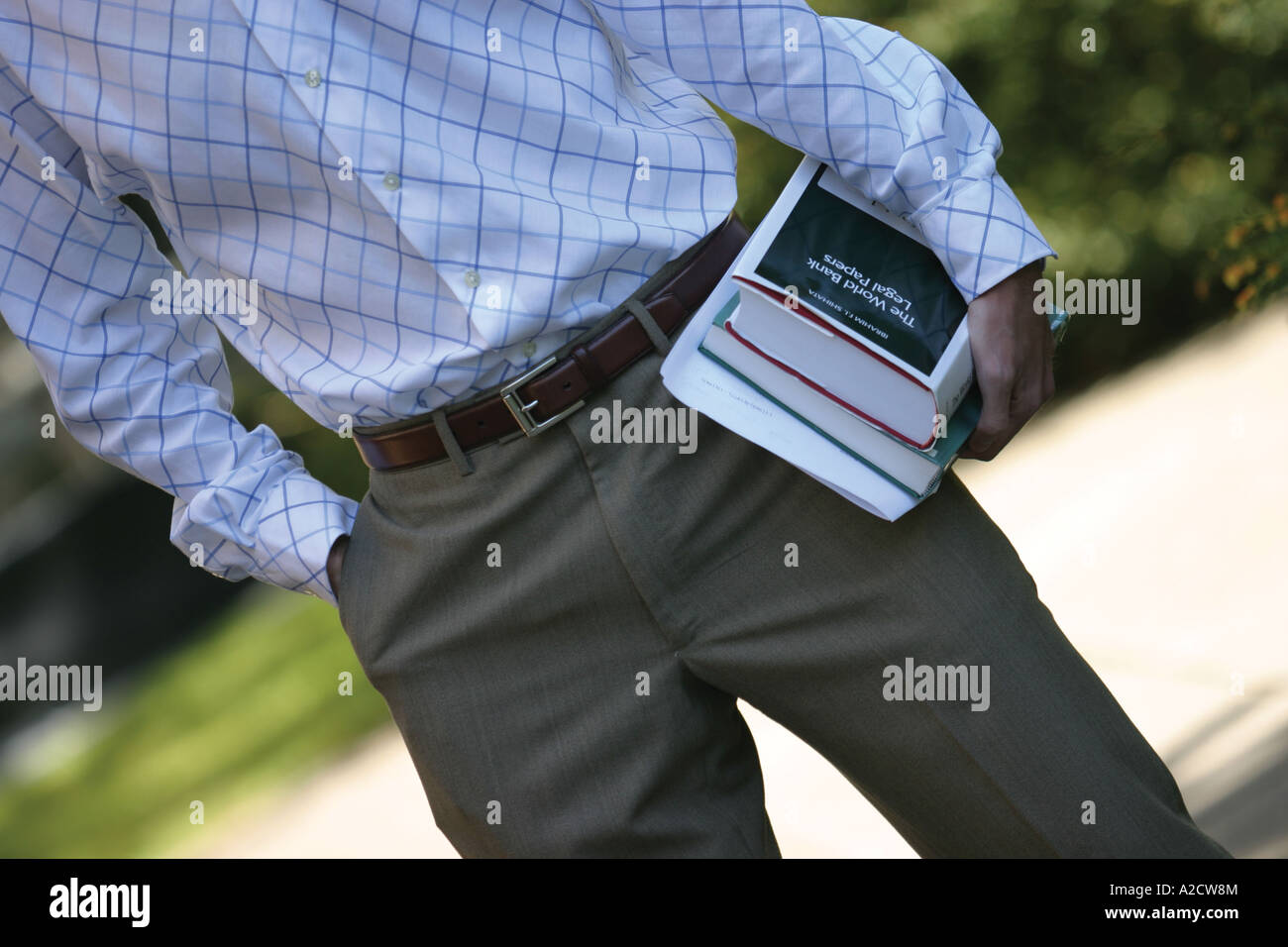 Student holding textbook at University Stock Photo - Alamy