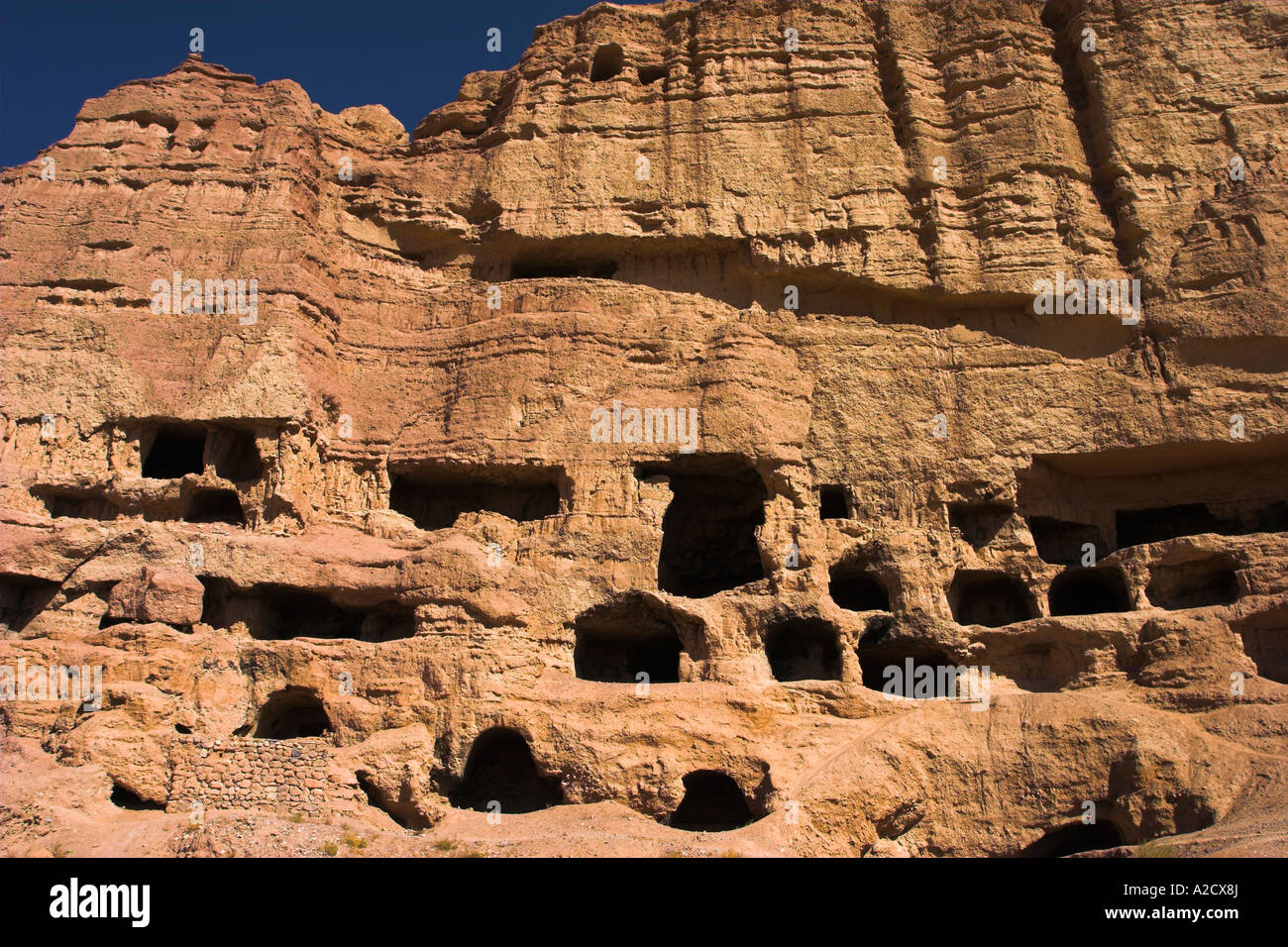 AFGHANISTAN Bamiyan Province Caves in cliffs near empty niche where the ...
