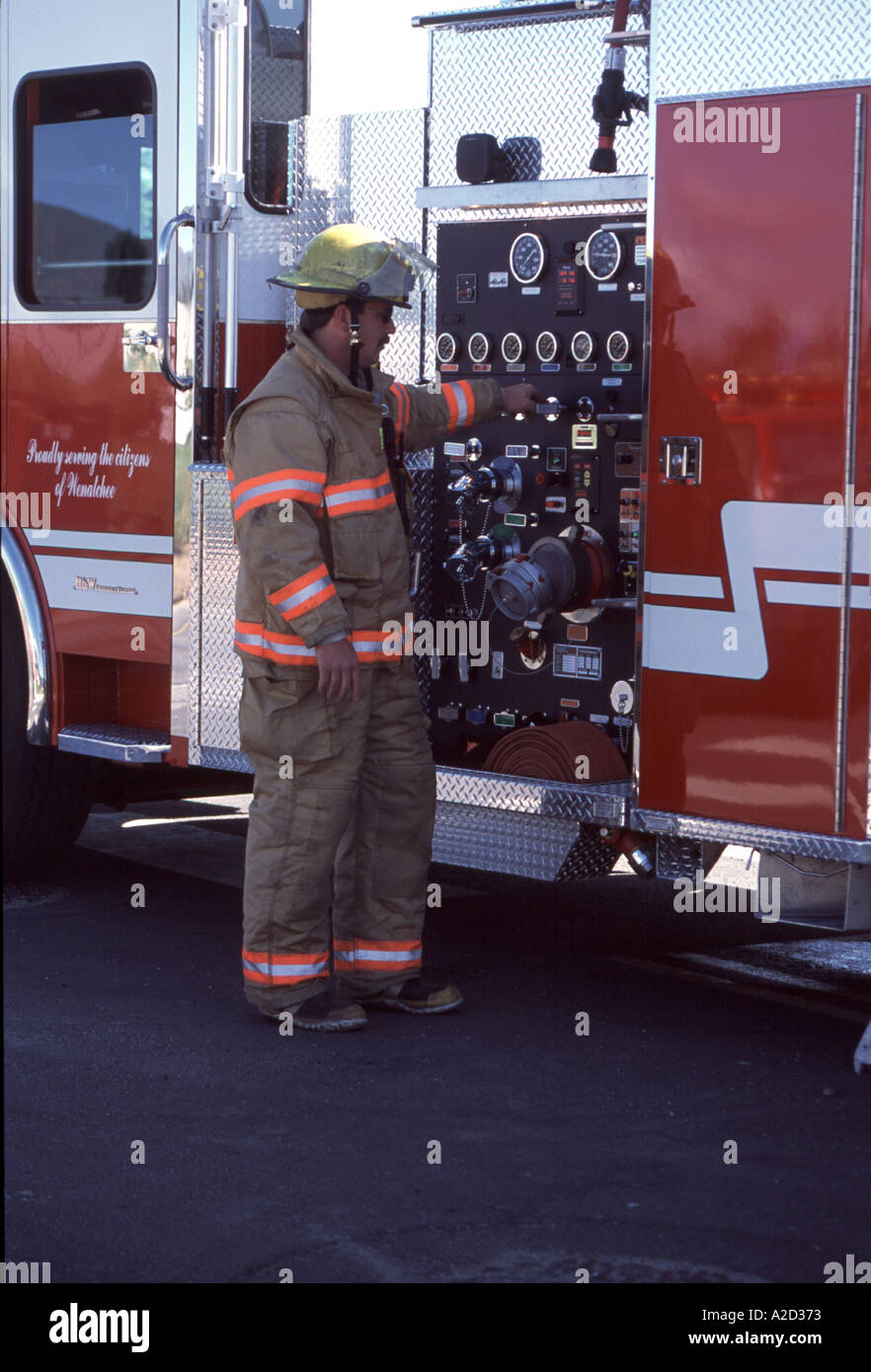 Fireman at fire truck control panel Stock Photo - Alamy