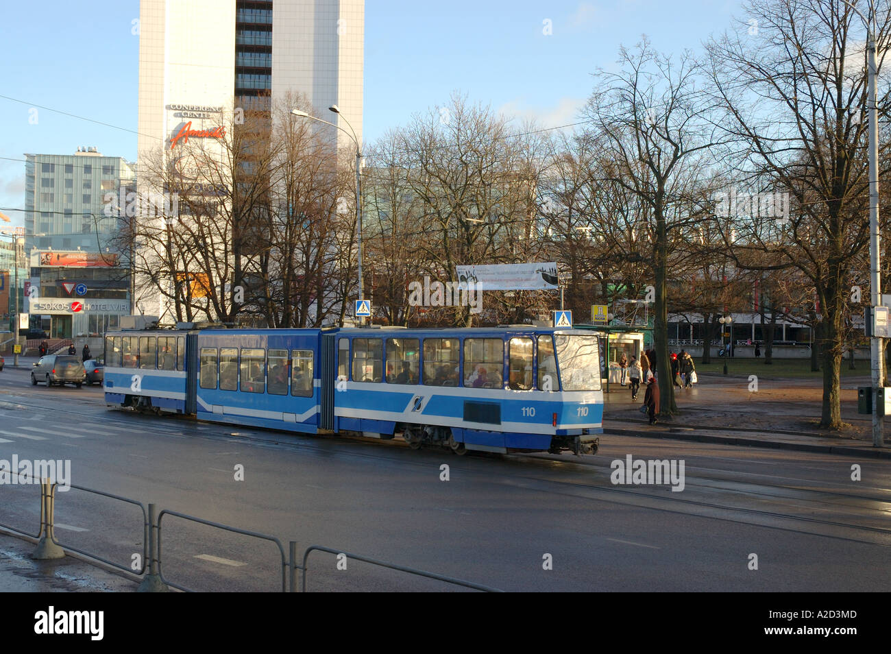 Tram travelling in the middle of the road Stock Photo - Alamy