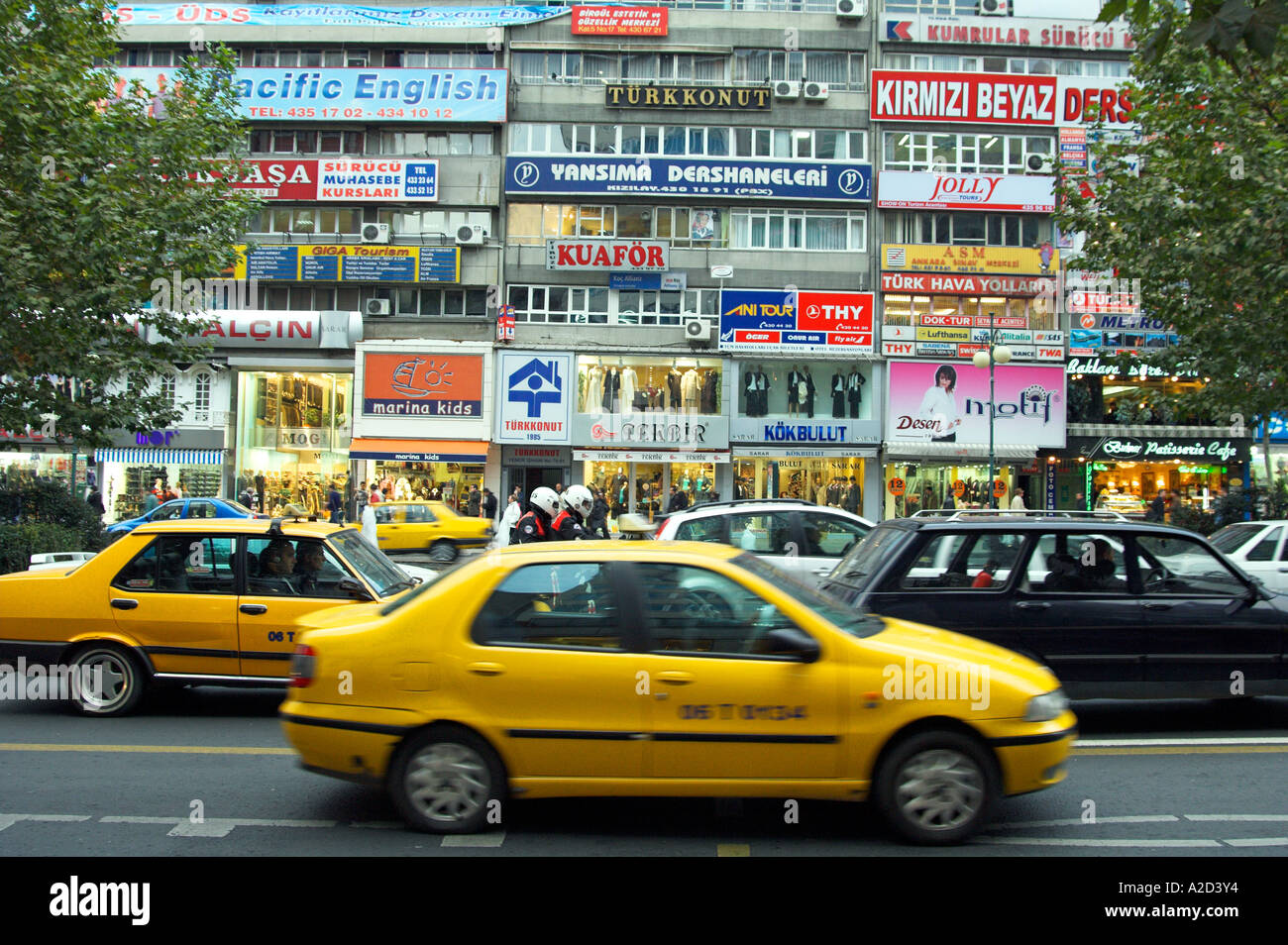 Busy street traffic and colorful buisiness signs on Ataturk Boulevard ...