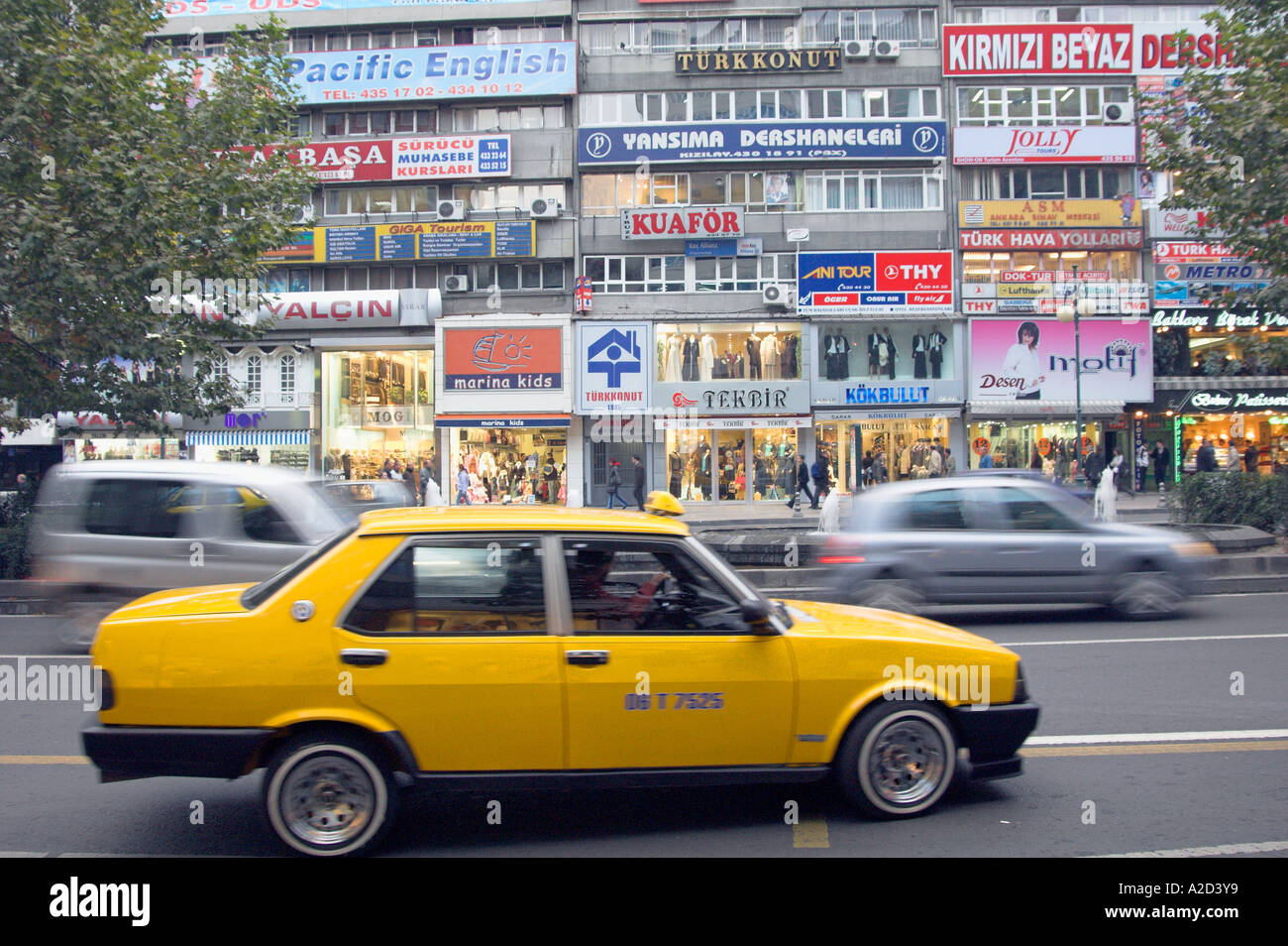 Busy street traffic and colorful buisiness signs on Ataturk Boulevard ...