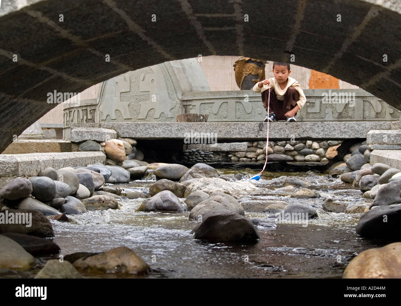 Asian boy playing in stream hi-res stock photography and images - Alamy