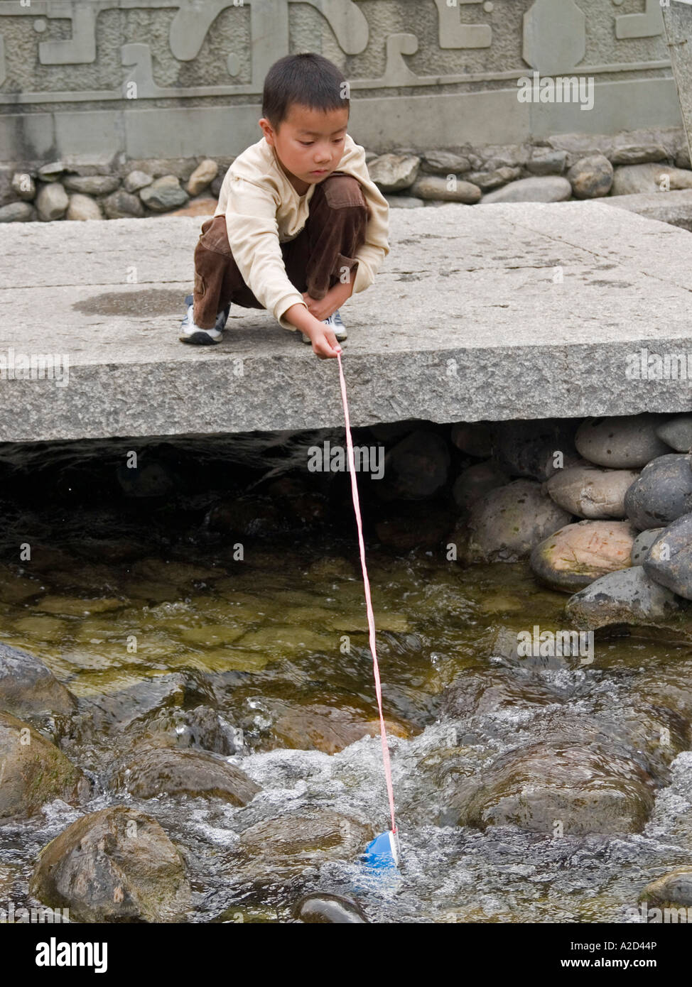 a boy and his boat Dali China Stock Photo - Alamy