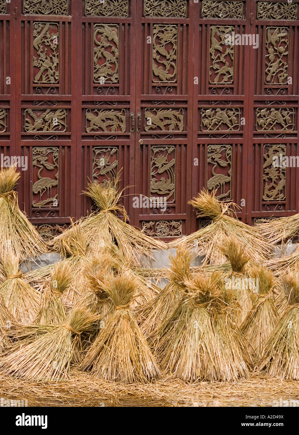rice straw stacked against Chinese temple doors Dali China Stock Photo ...