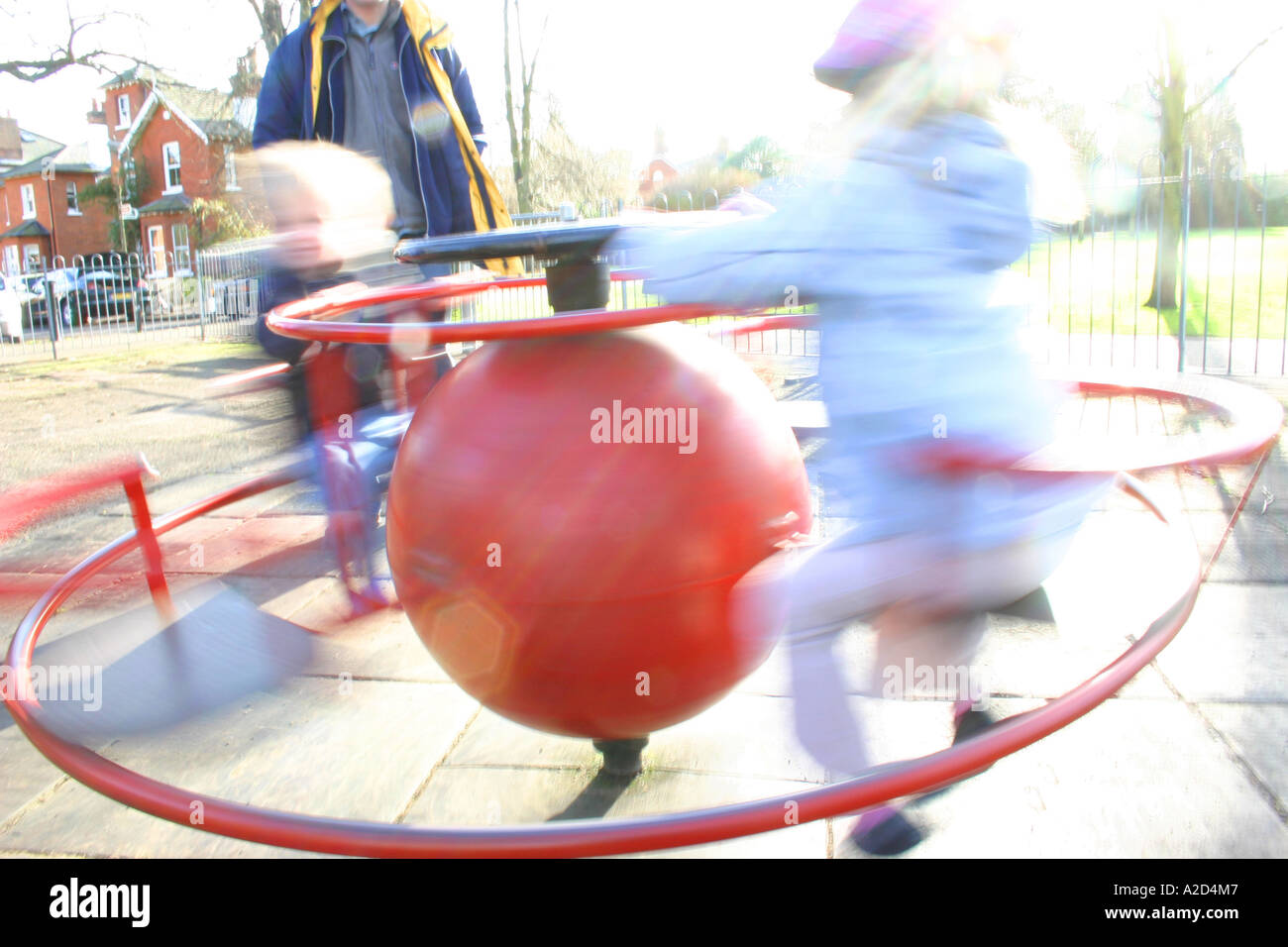 young children on spinning roundabout Stock Photo - Alamy