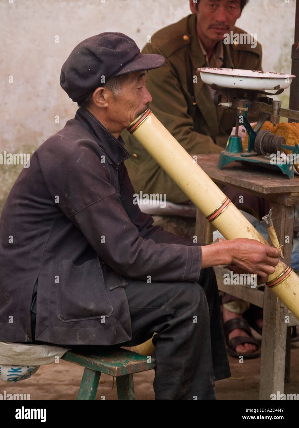 Hani man smoking the big pipe at market in Yuanyang China Stock Photo ...
