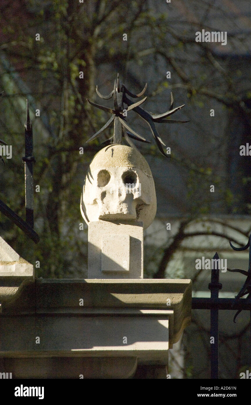Skull on railing spike at St olaves churchyard in the city of London ...