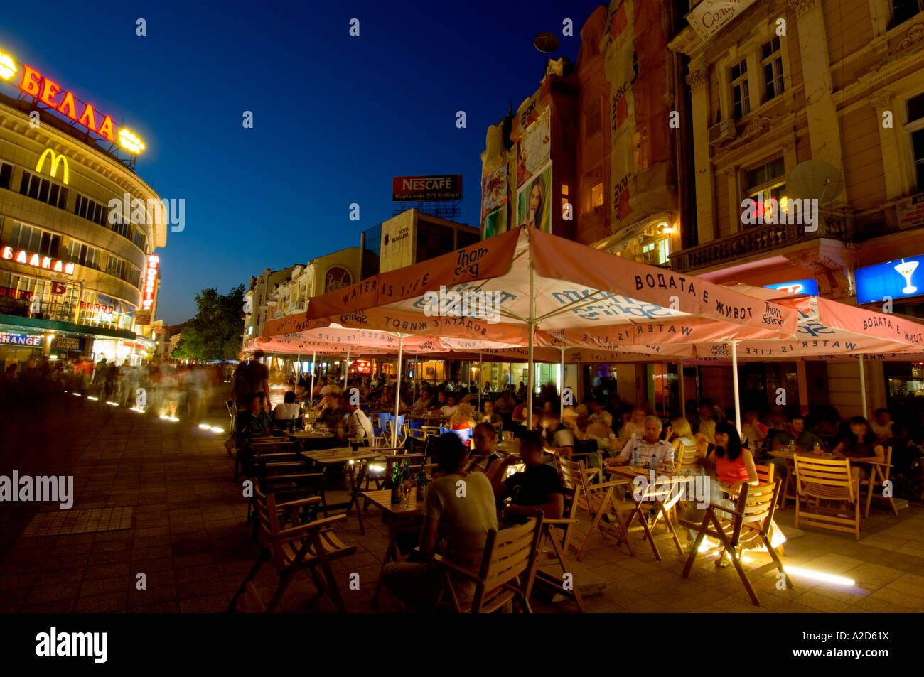 People in busy sidewalk cafe bar at night Plovdiv Bulgaria Stock Photo ...