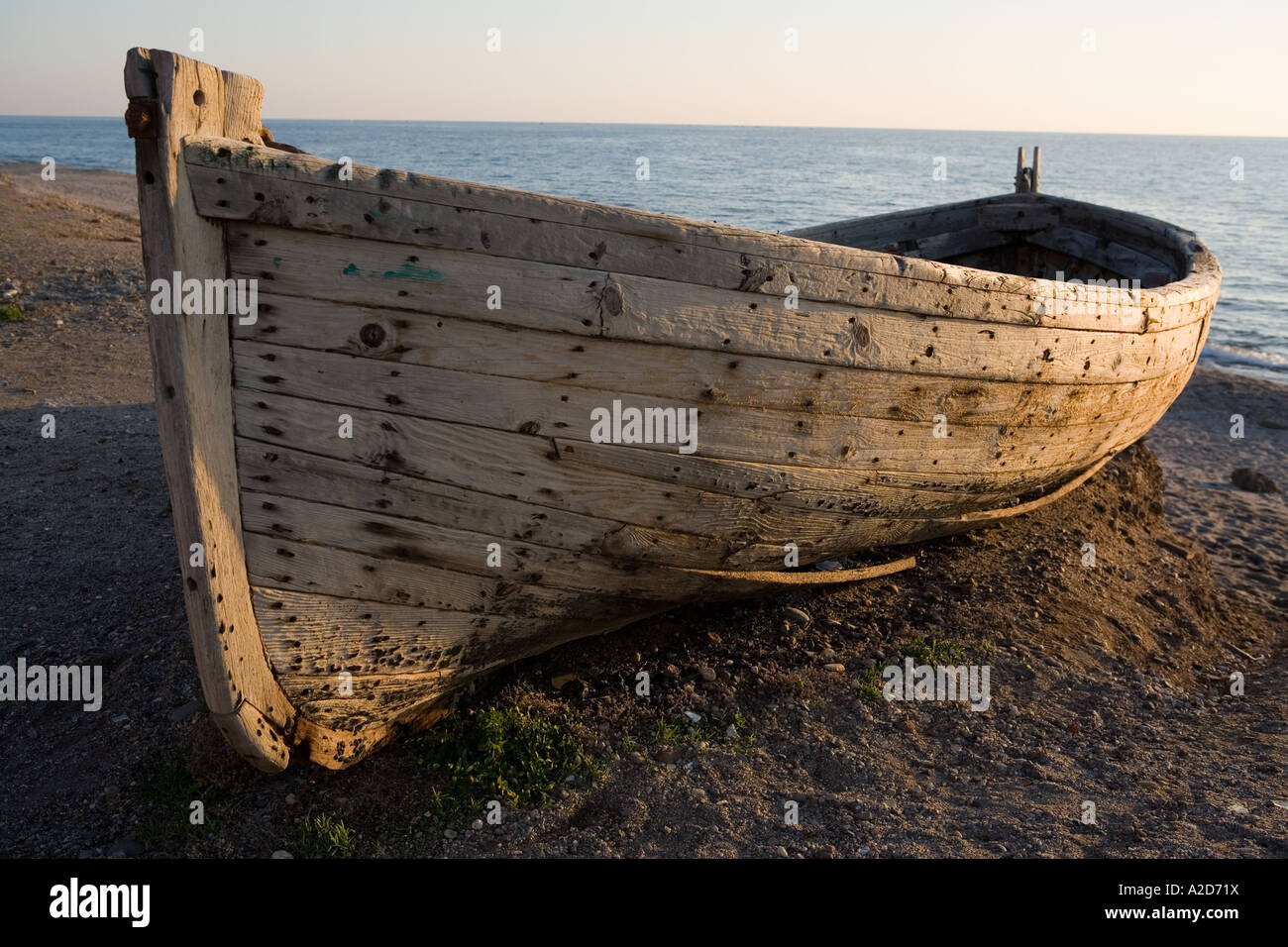 Old wooden boat stranded at the beach Stock Photo - Alamy
