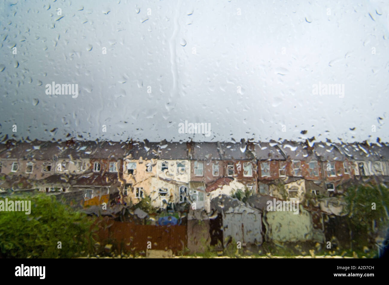 View of the back of Victorian terrace in England through a rain soaked ...