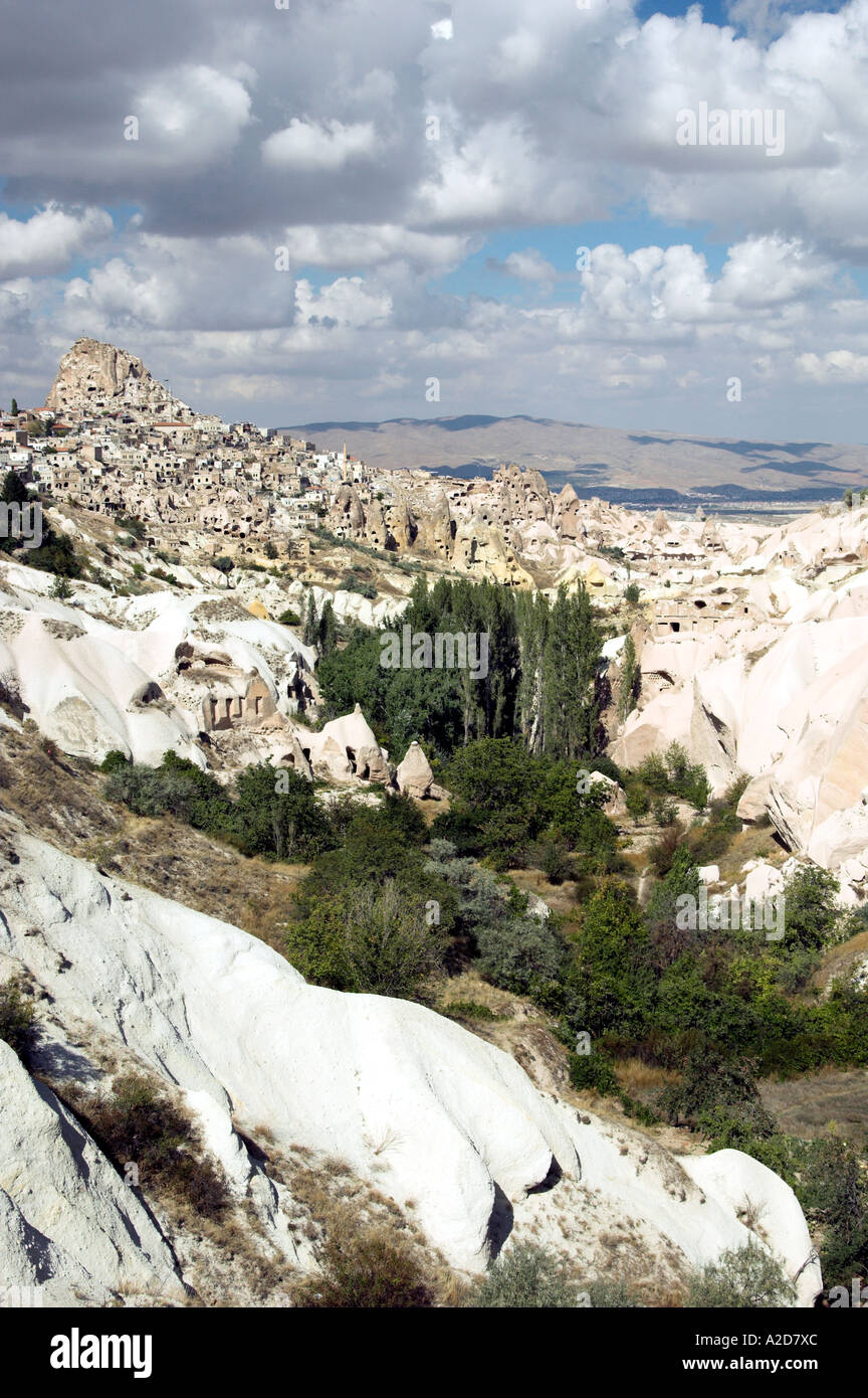 The volcanic landscape of cone shaped rock carved caves and dwellings ...
