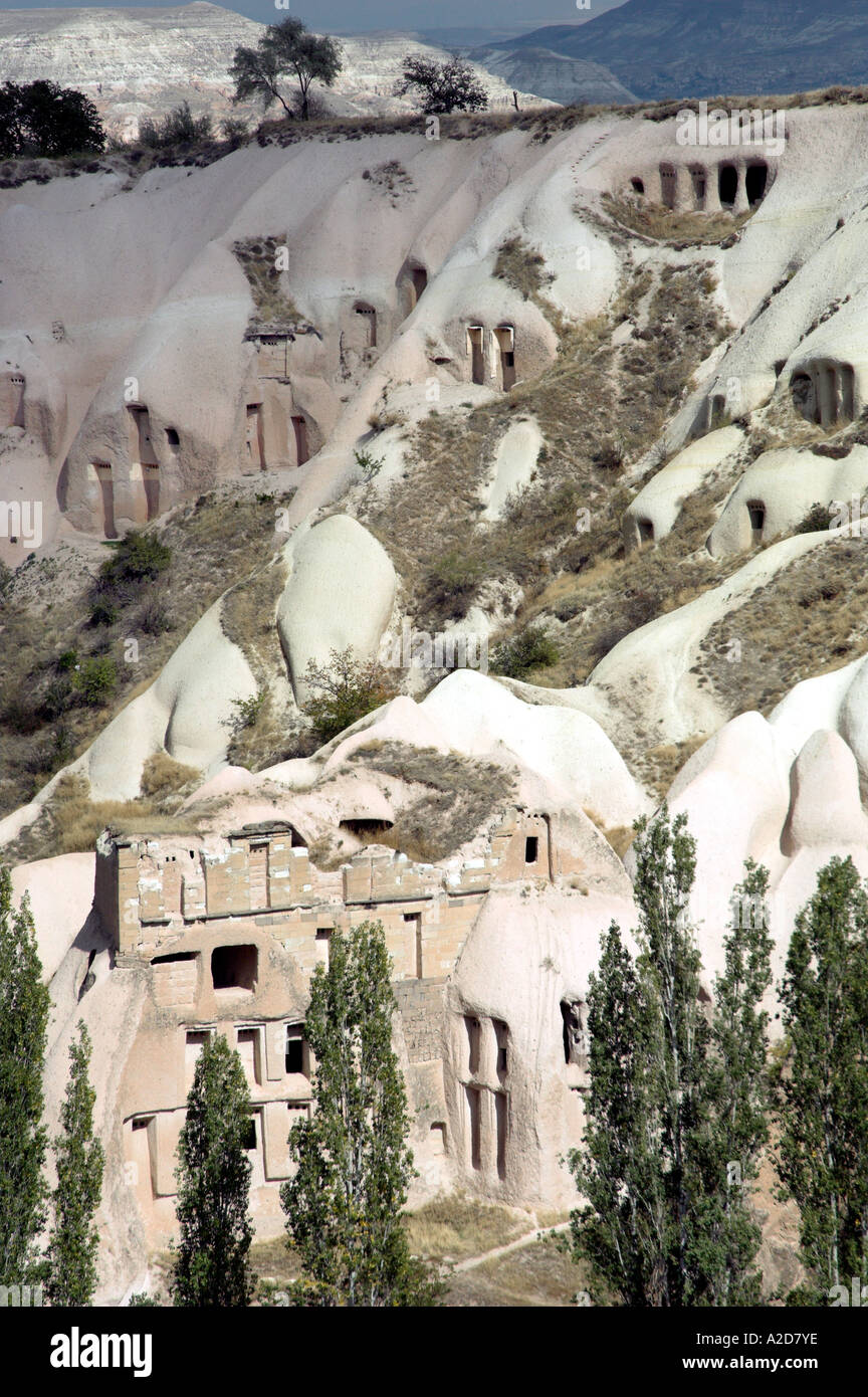 The volcanic landscape of cone shaped rock carved caves and dwellings ...