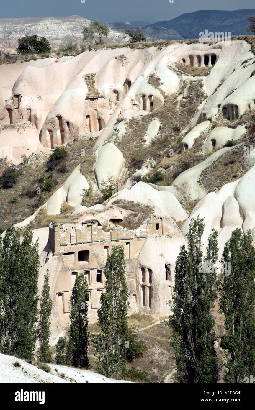 The volcanic landscape of cone shaped rock carved caves and dwellings ...