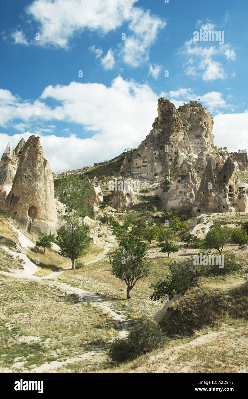 The volcanic landscape of cone shaped rock carved caves and dwellings ...