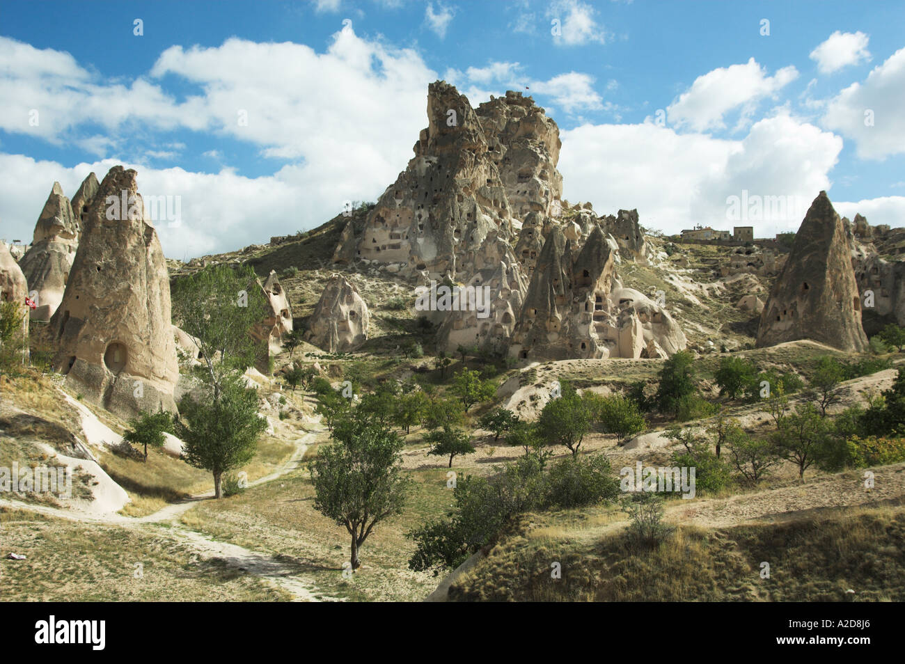 The volcanic landscape of cone shaped rock carved caves and dwellings ...
