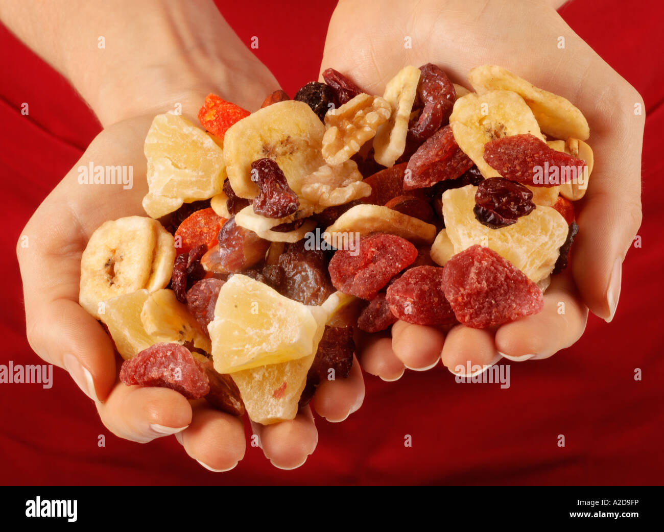 WOMAN HOLDING HANDFUL OF DRIED FRUIT AND NUTS Stock Photo - Alamy
