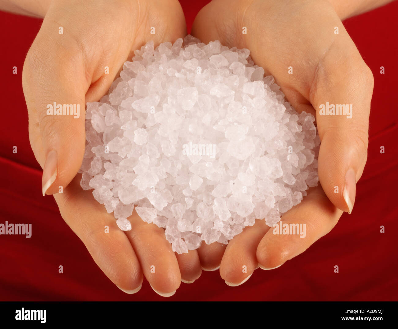 HANDFUL OF ROCK SALT Stock Photo - Alamy