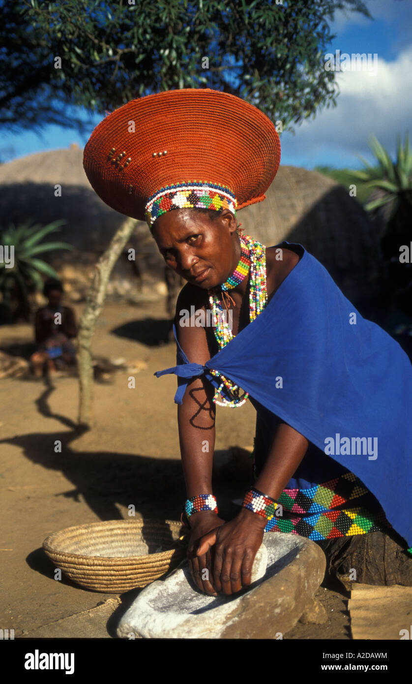 Zulu married woman wearing a traditional hat grinding maize Kwazulu ...