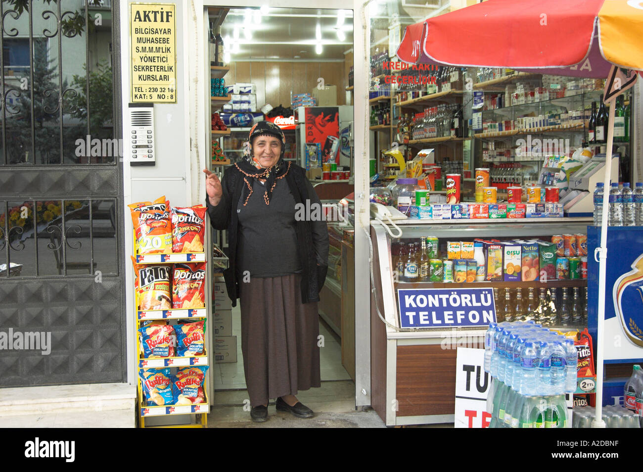 A lady shop keeper poses for a picture in front of their business on ...