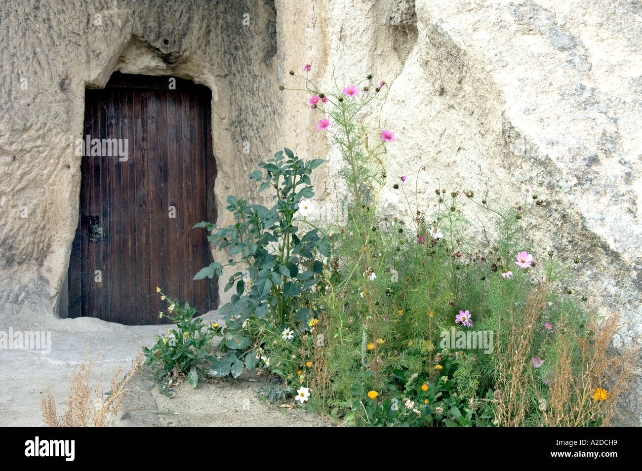 Doors and arches leading to cave interiors carved into the volcanic ...