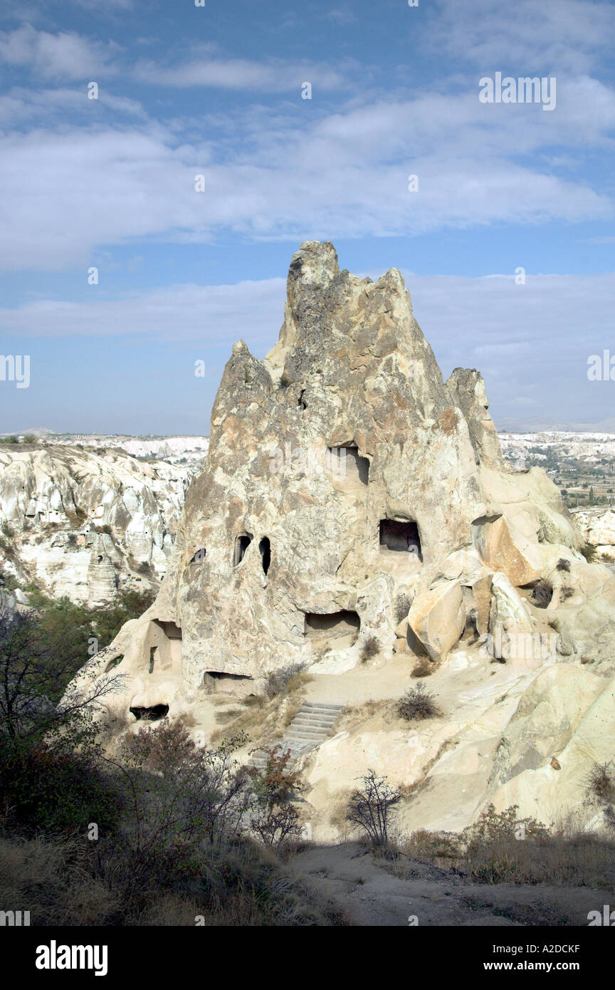 The volcanic landscape of cone shaped rock carved caves and dwellings ...