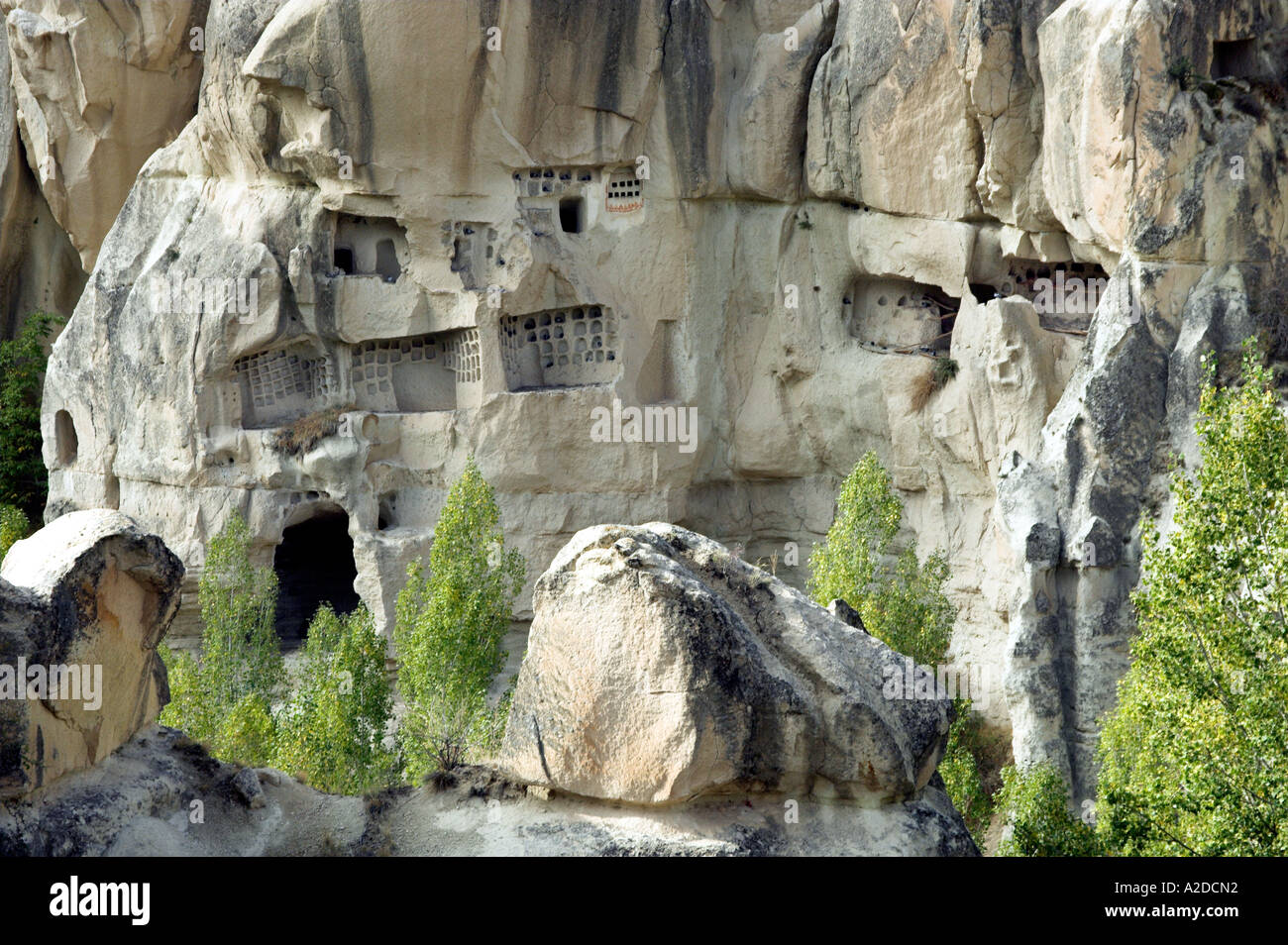 The volcanic landscape of cone shaped rock carved caves and dwellings ...