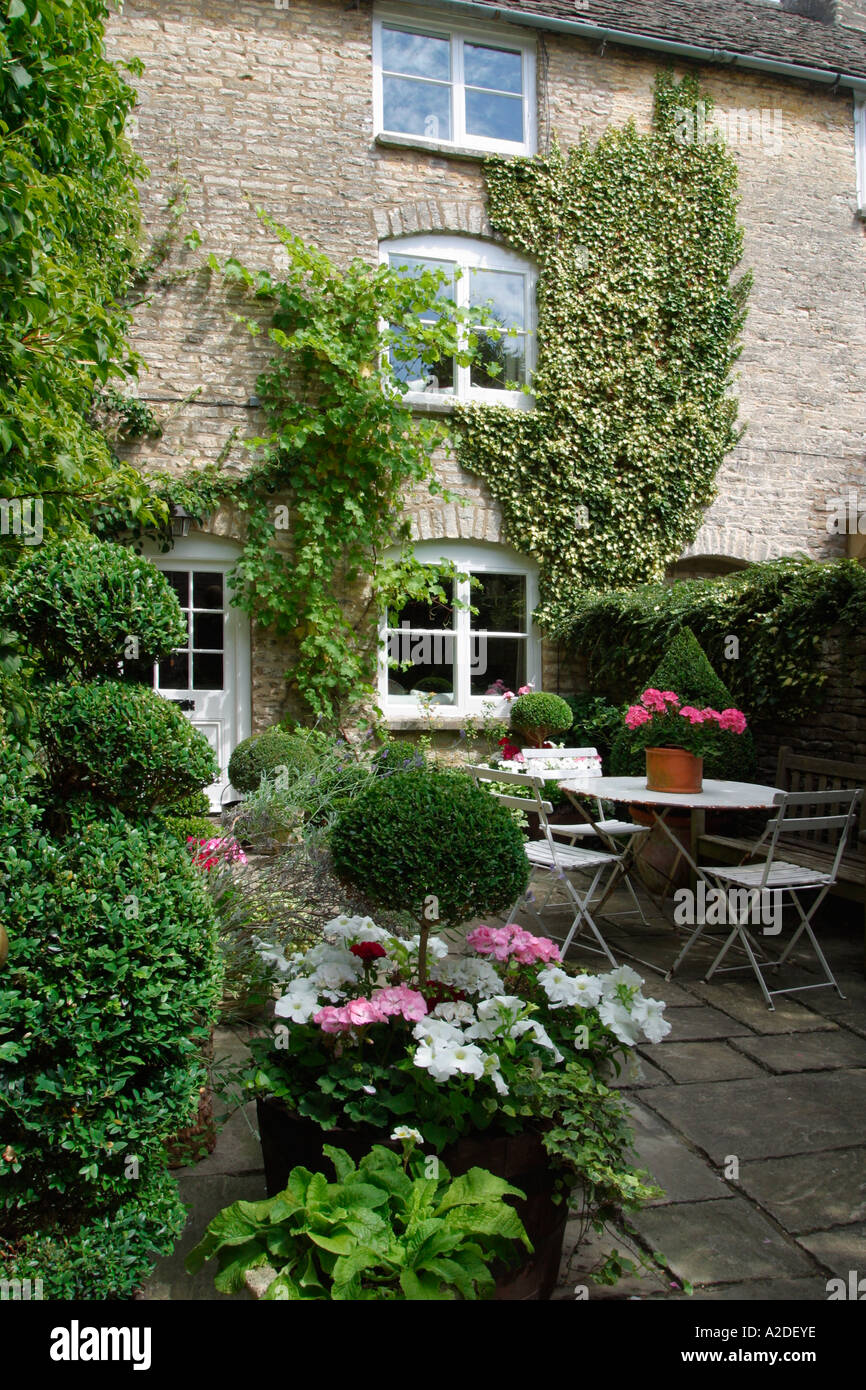 Pretty UK garden patio terrace, table and chairs Stock Photo - Alamy