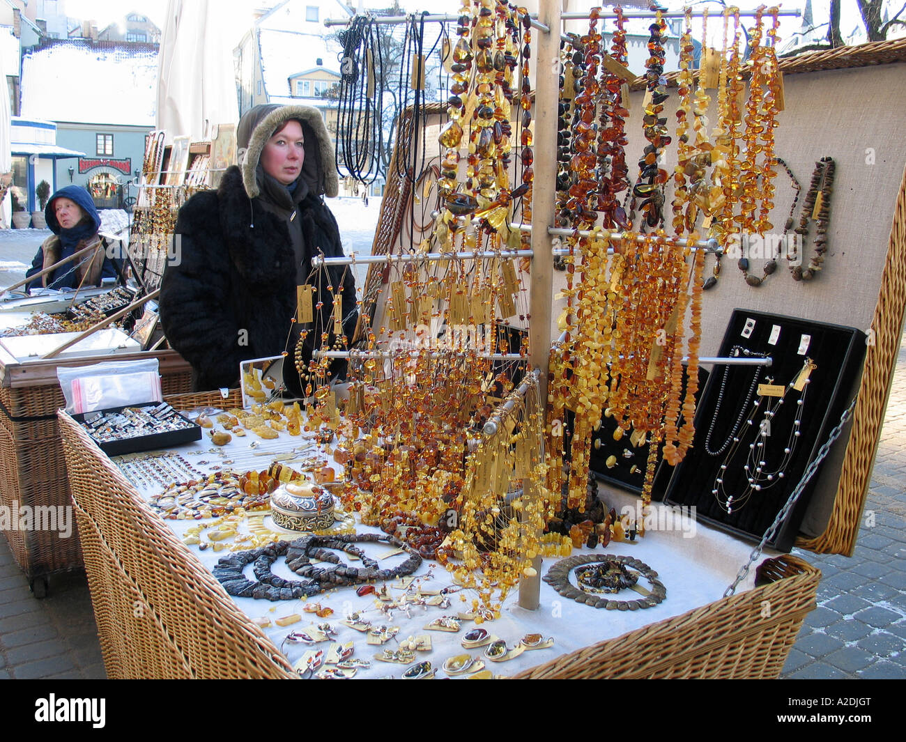 A market stall holder sells amber jewellery in the centre Riga Latvia ...