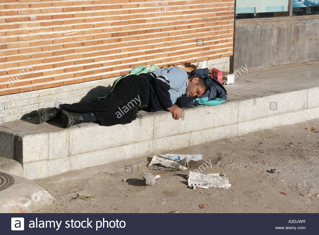 A Spanish homeless man sleeps on a step in Toledo Spain Stock Photo ...