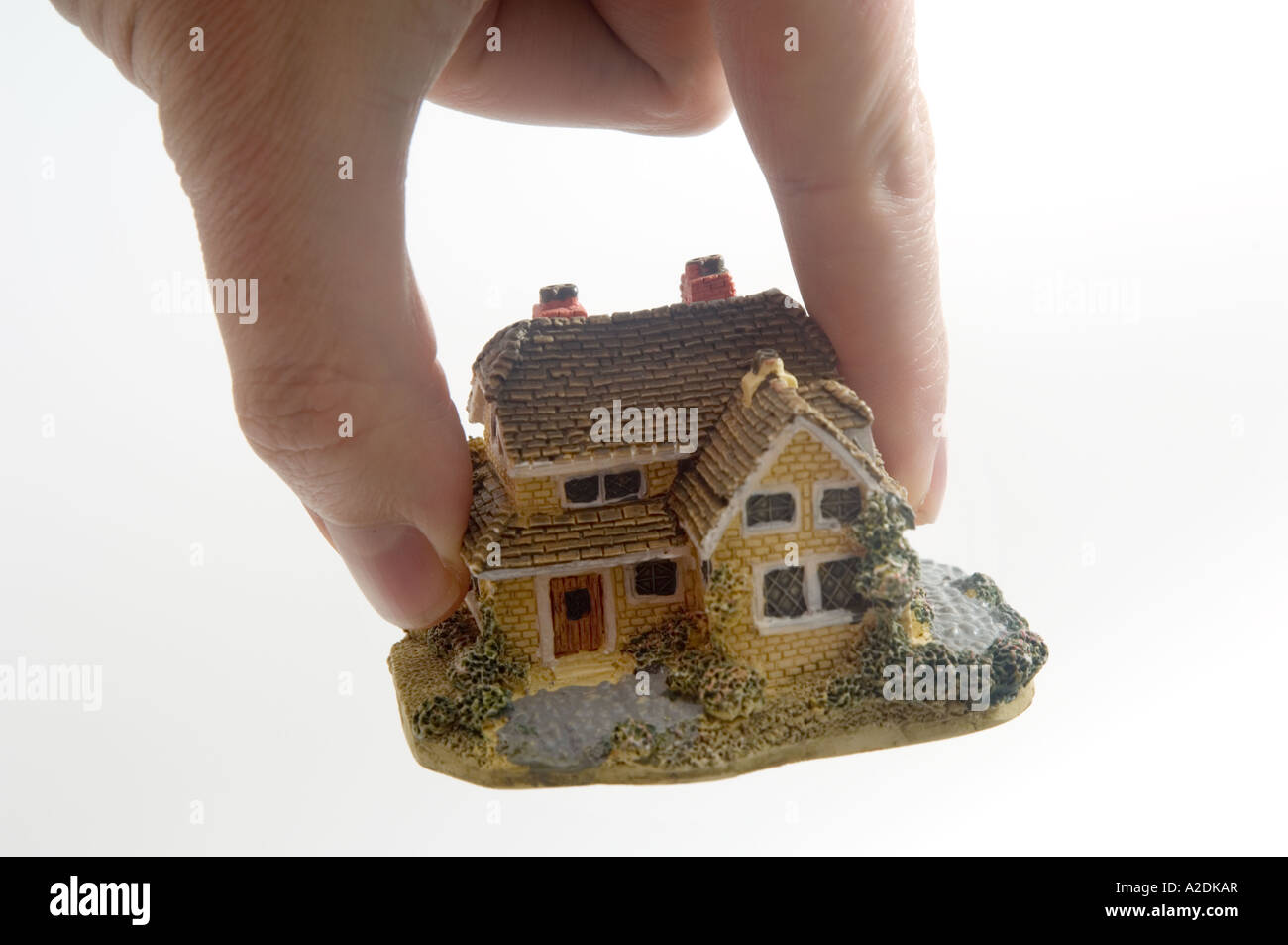 moving house hand with model house Stock Photo - Alamy