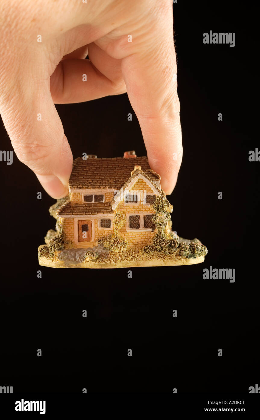 moving house hand with model house Stock Photo - Alamy