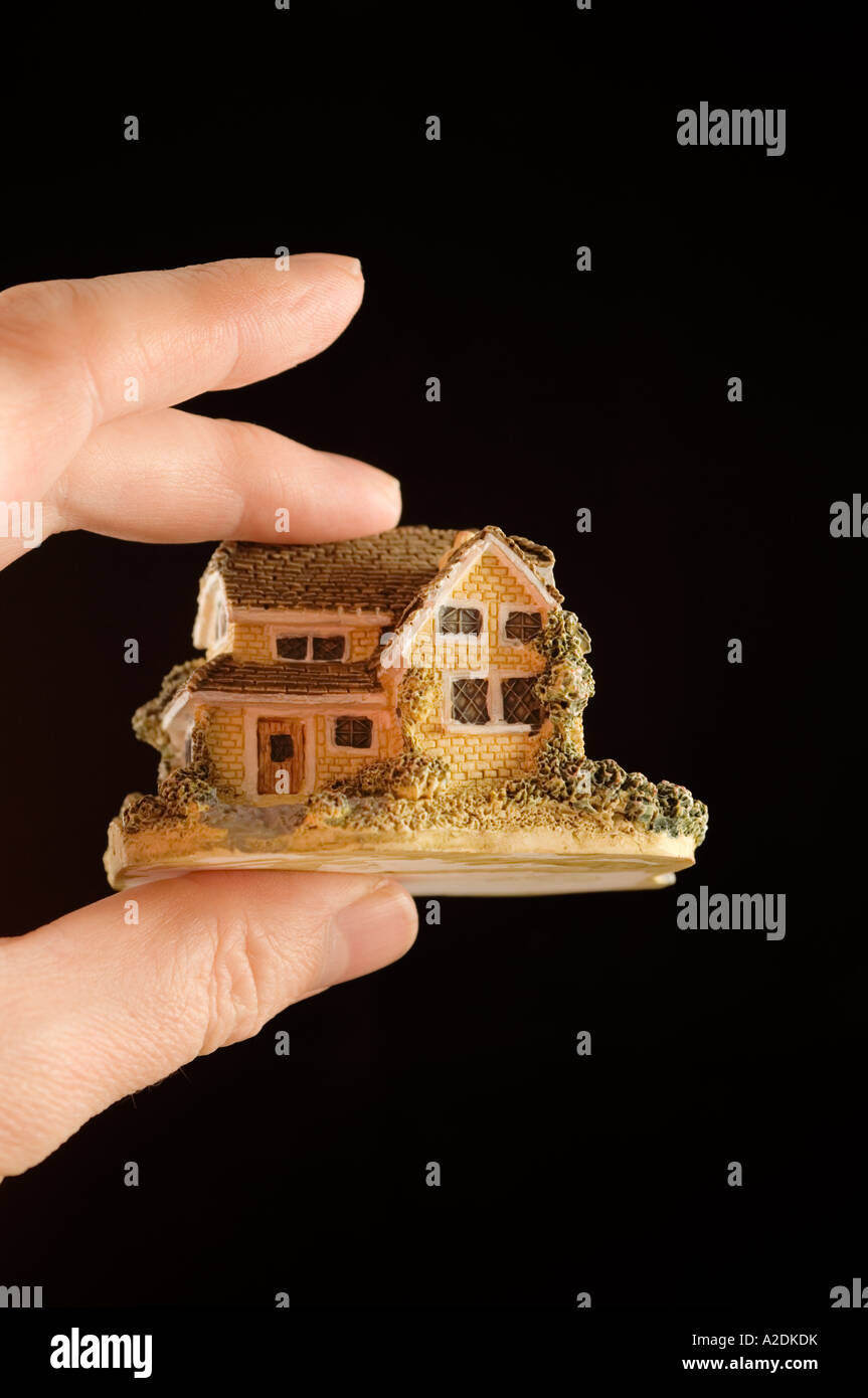 moving house hand with a model house Stock Photo - Alamy