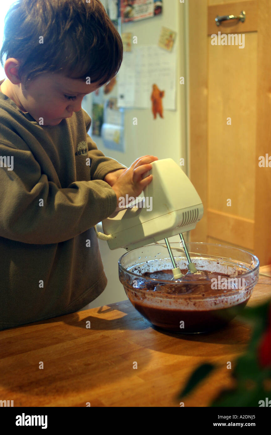 Lewis aged four baking a cake mixing the ingredients Stock Photo - Alamy