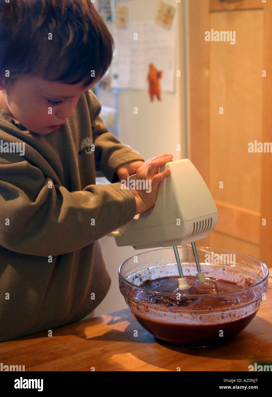 boy aged four baking a cake mixing the ingredients Stock Photo - Alamy