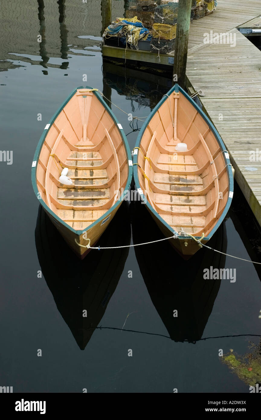 Twin wooden rowing boats or dorys in Gloucester Massachusetts harbor ...