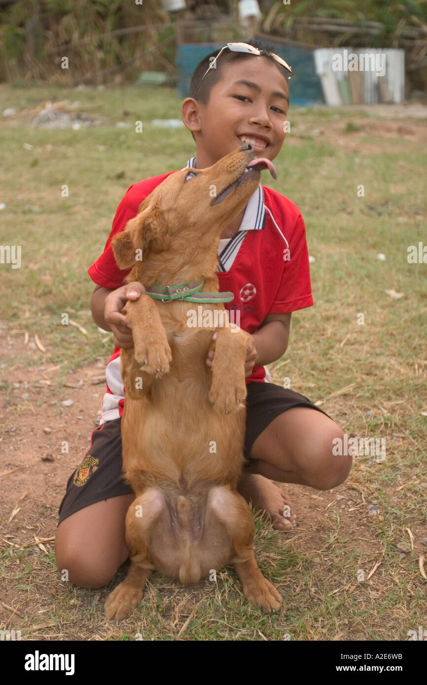 Asia, Thailand, Khon Kaen, Thai boy and dog Stock Photo - Alamy