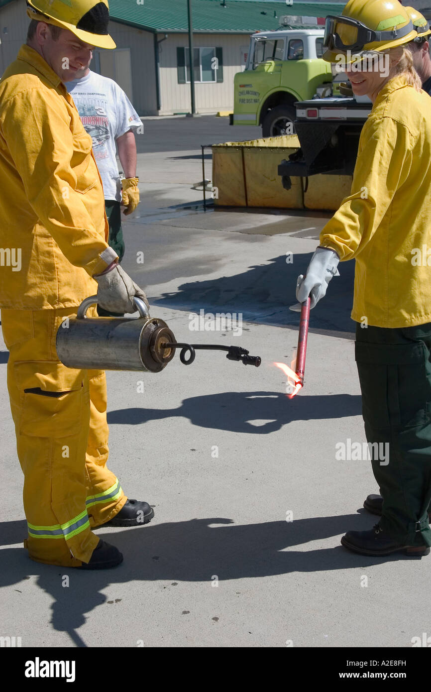 Firefighters lighting a drip tourch at a Wildland Acadamy training ...
