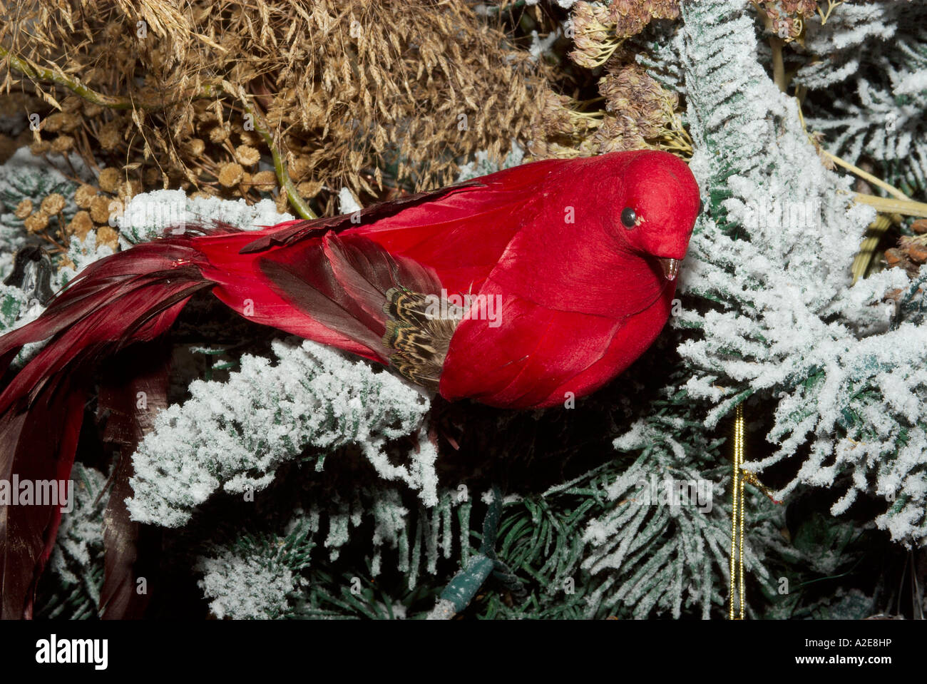 A red bird tree ornament on a Christmas tree that will be auctioned off ...