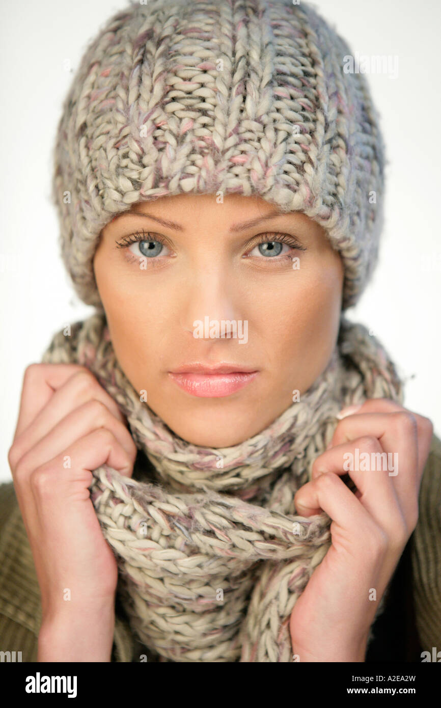 Young woman wearing cap and scarf Stock Photo - Alamy