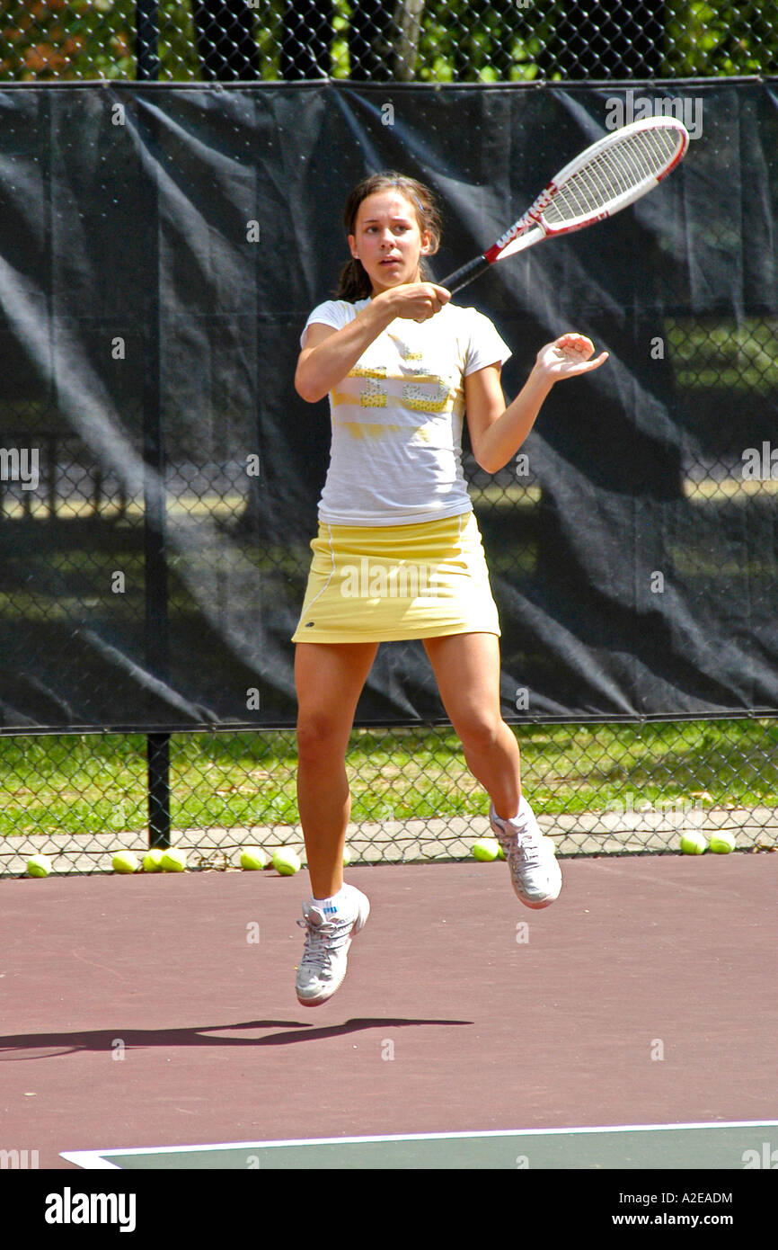 Teenage female taking Tennis lessons in a public summer-school program ...