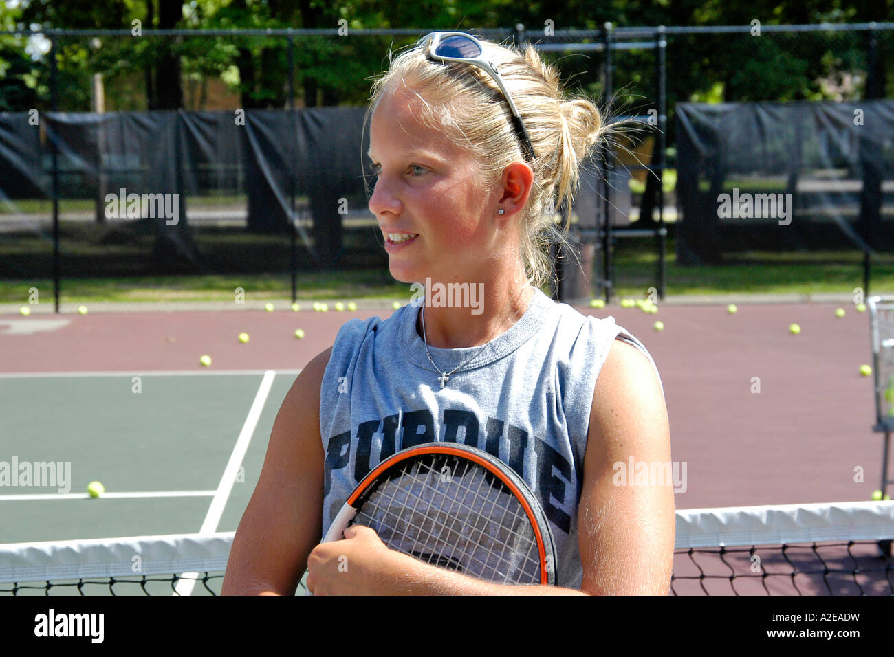 Female Tennis Coach giving lessons at a public summer-school program ...