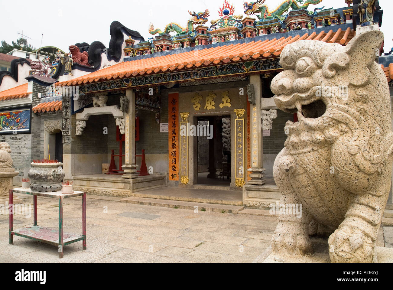 dh CHEUNG CHAU HONG KONG Carved lion statue standing guard outside ...