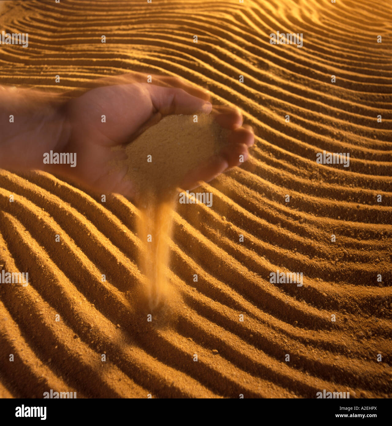 Hand Pouring Sand Stock Photo - Alamy