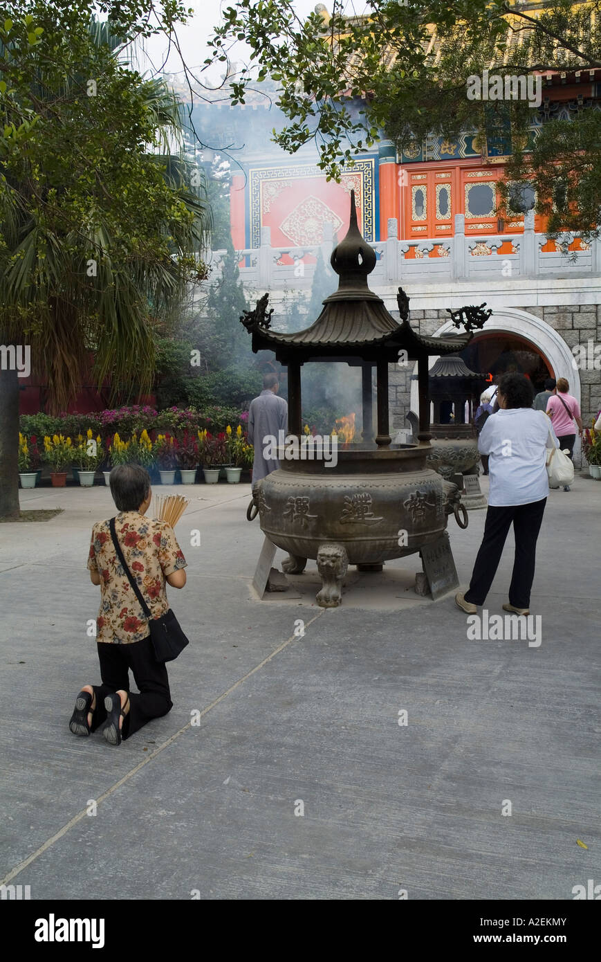 Woman praying incense temple entrance hi-res stock photography and ...