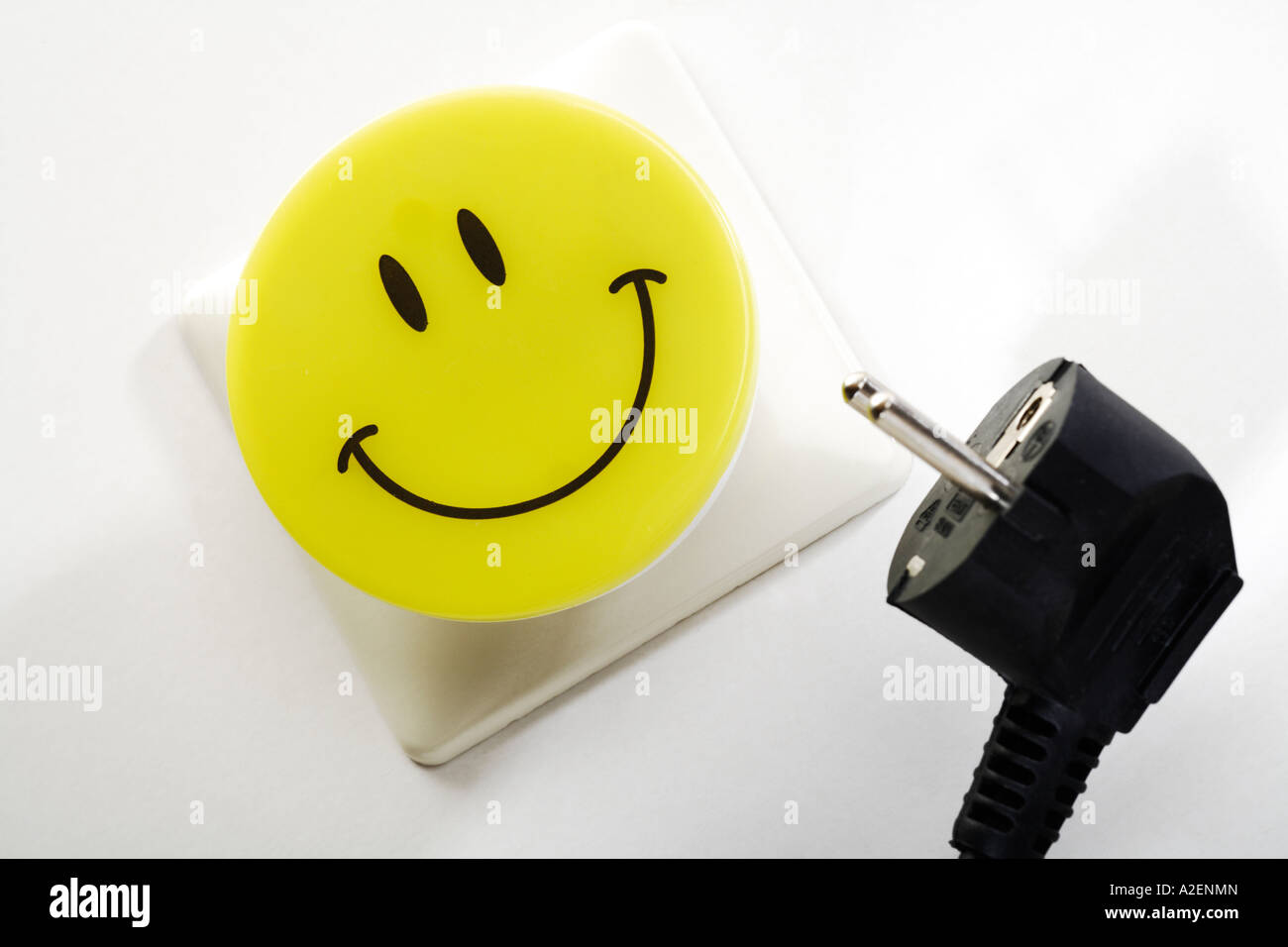 Socket, plug and night light with smiley logo Stock Photo - Alamy