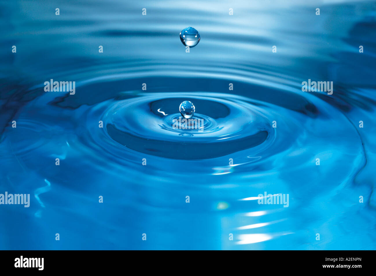 Water drop falling into water, close-up Stock Photo - Alamy