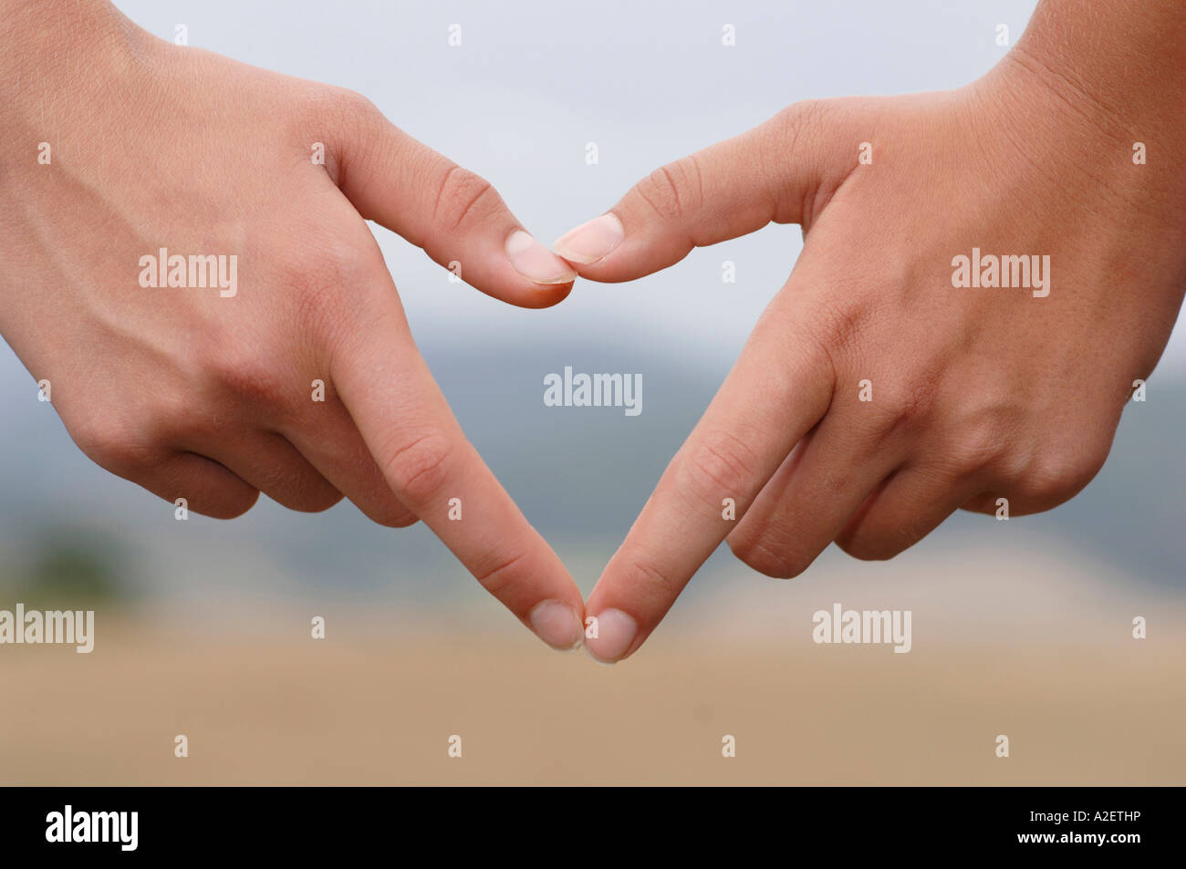 Two hands creating heart, close-up Stock Photo - Alamy