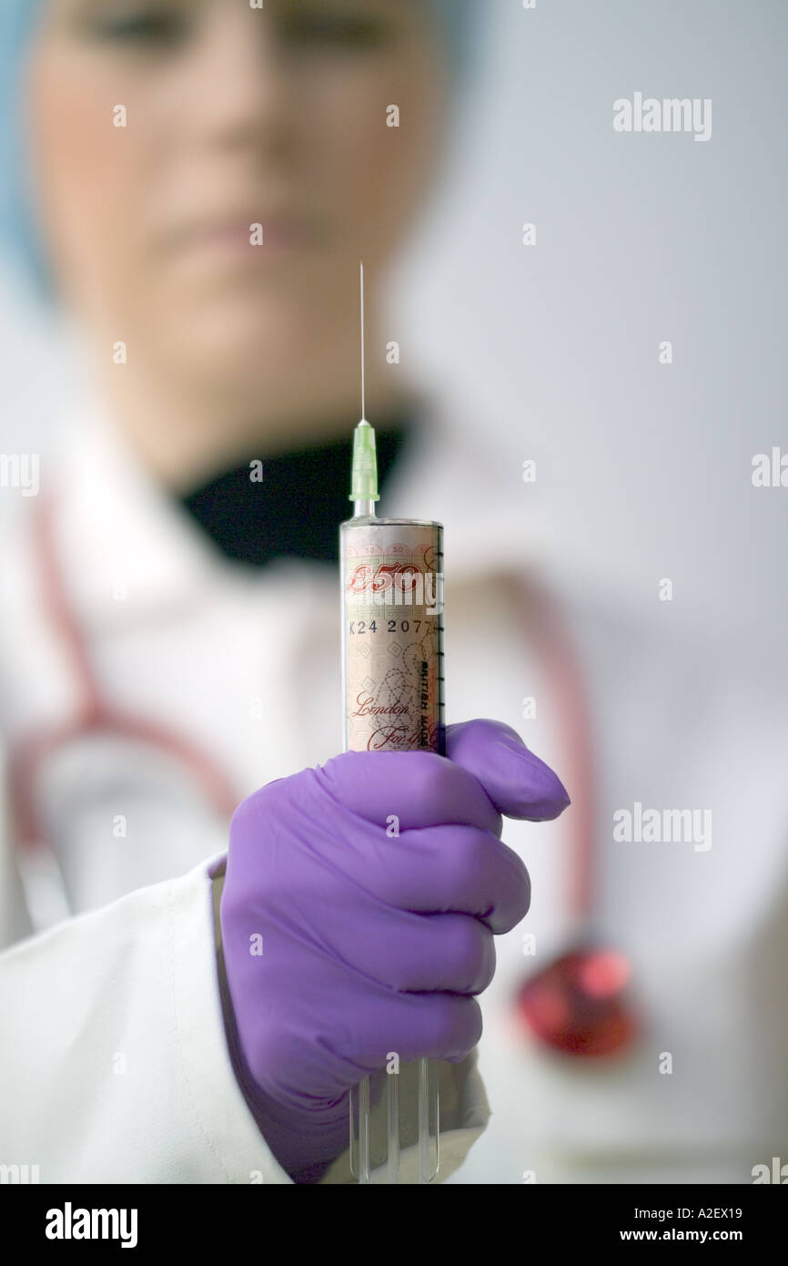 Medical NHS Cash injection 50 note in syringe held by doctor Stock ...