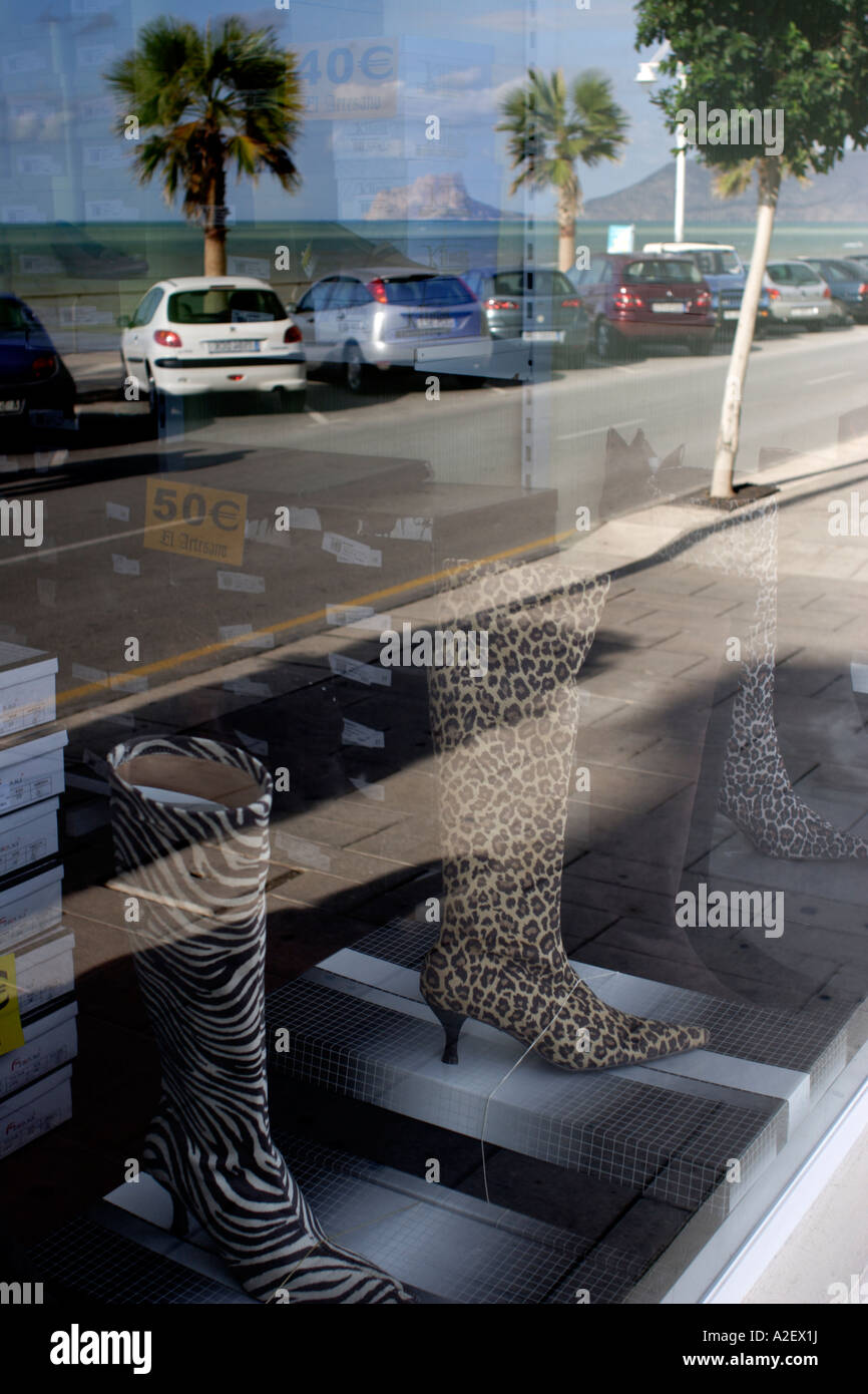 Womens calf length fashion animal skin boots on display in shop window ...